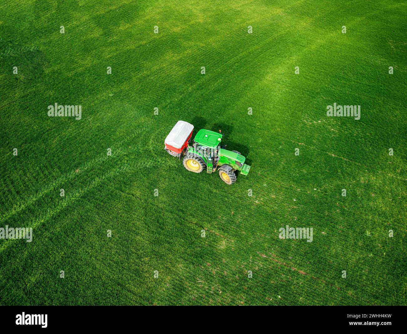 Aerial view of a tractor spraying the field. Chemistry in agriculture ...