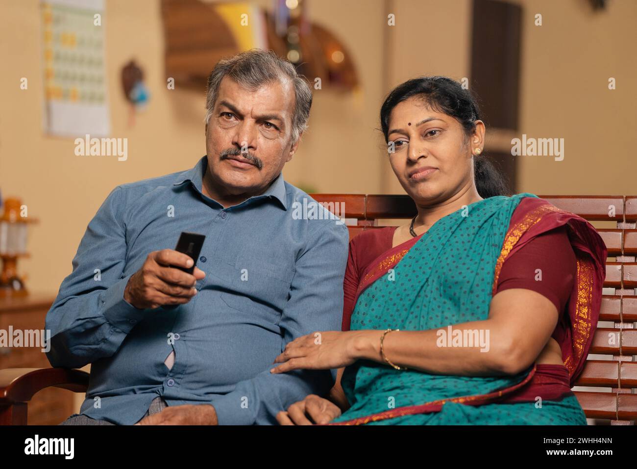 Indian elderly senior couples watching tv or television at home by ...
