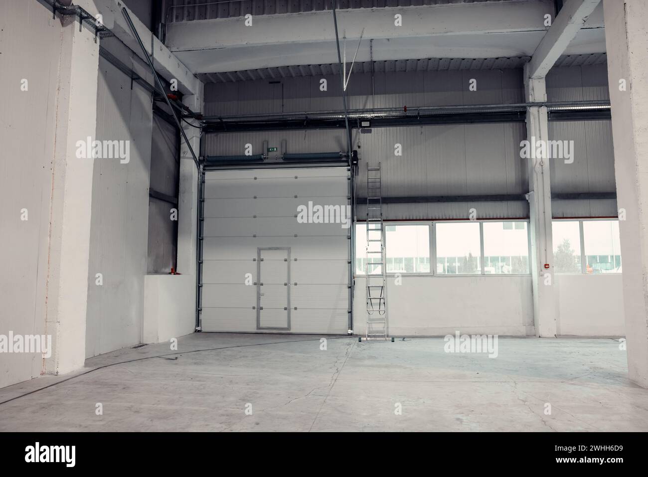 Roller shutter inside a warehouse. Painted and polished in white Stock ...