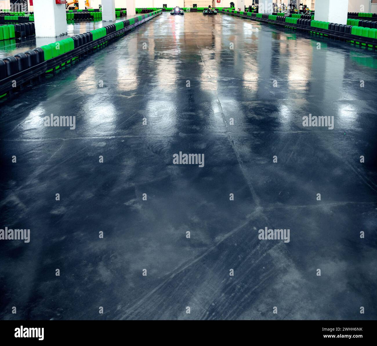Go-Kart Drivers are racing with speed on the texture black track Stock ...