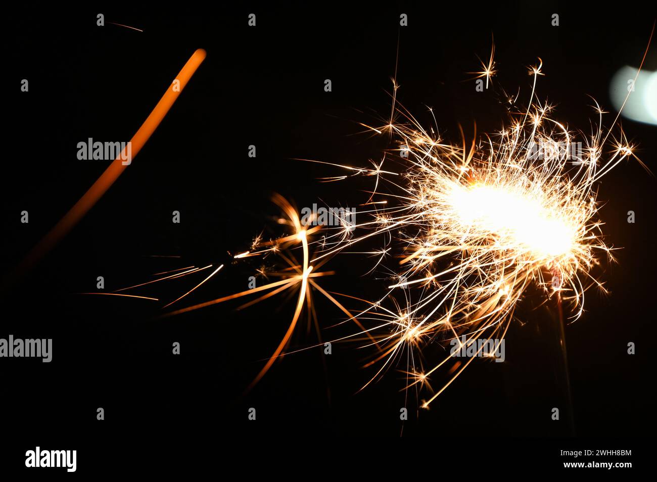Burning sparklers at night. New Year celebration. Burning Bengal fire ...