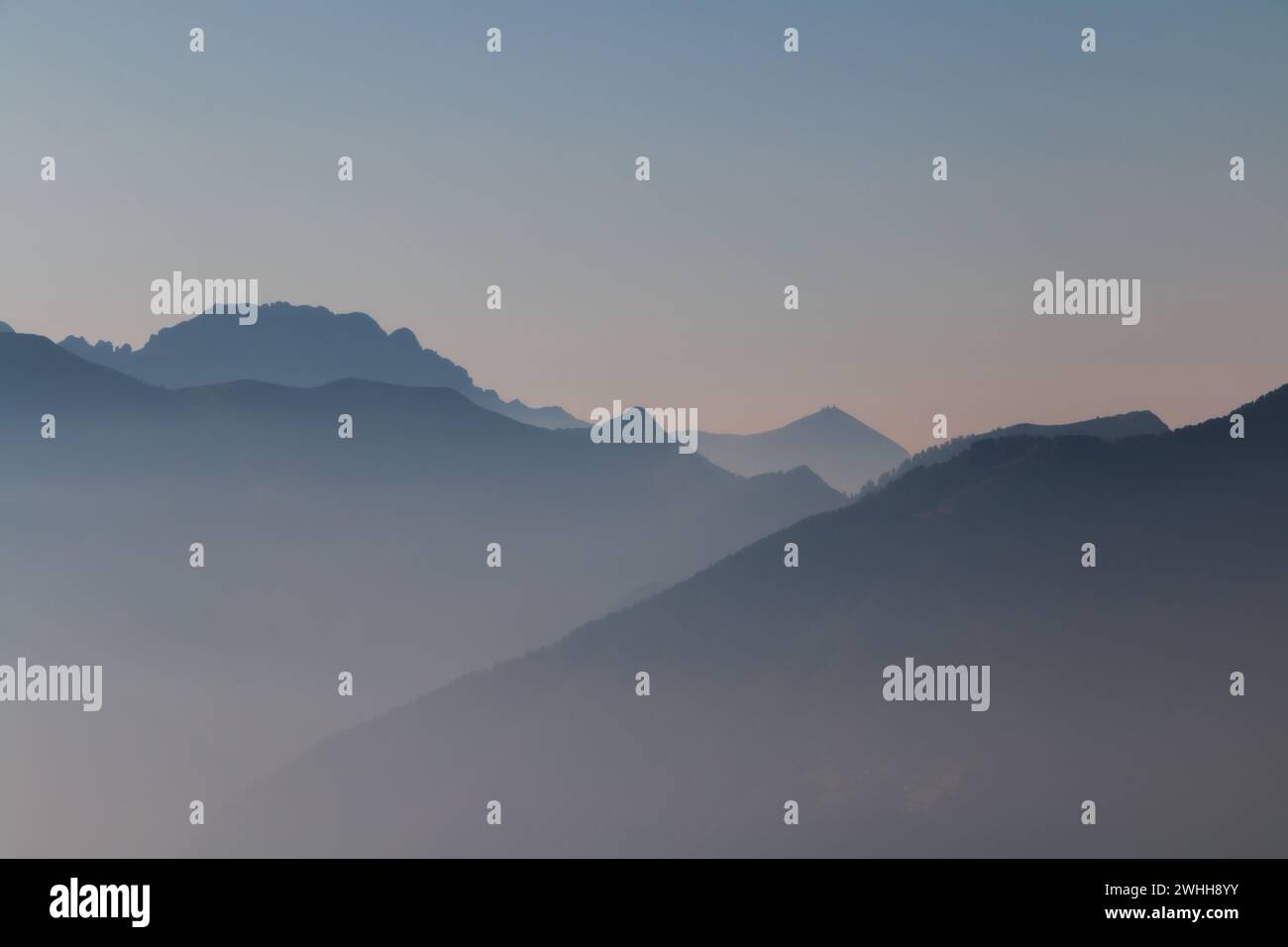 Spectacular mountain ranges silhouettes in morning Stock Photo - Alamy