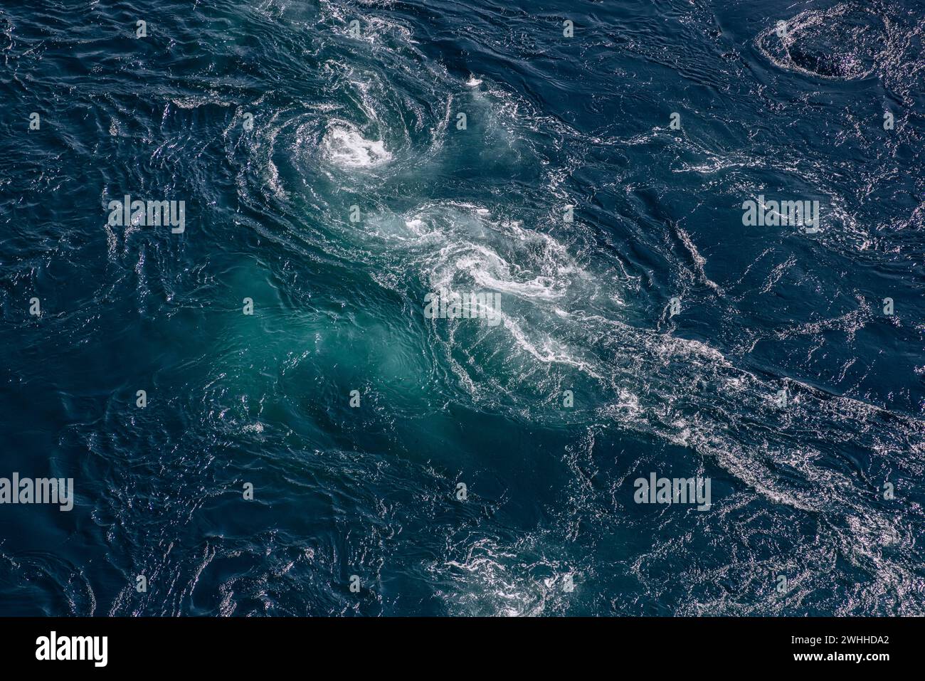 The deep blue of Saltstraumen's waters is accentuated by the vigorous ...