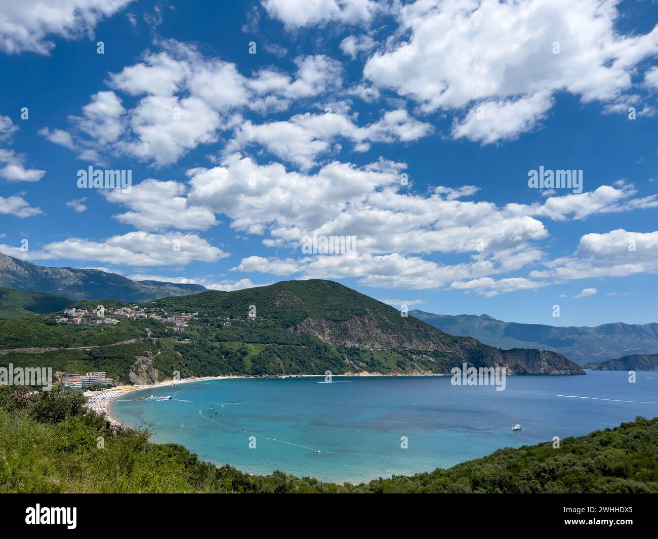 Blue bay in a valley between high mountains against a cloudy sky Stock ...