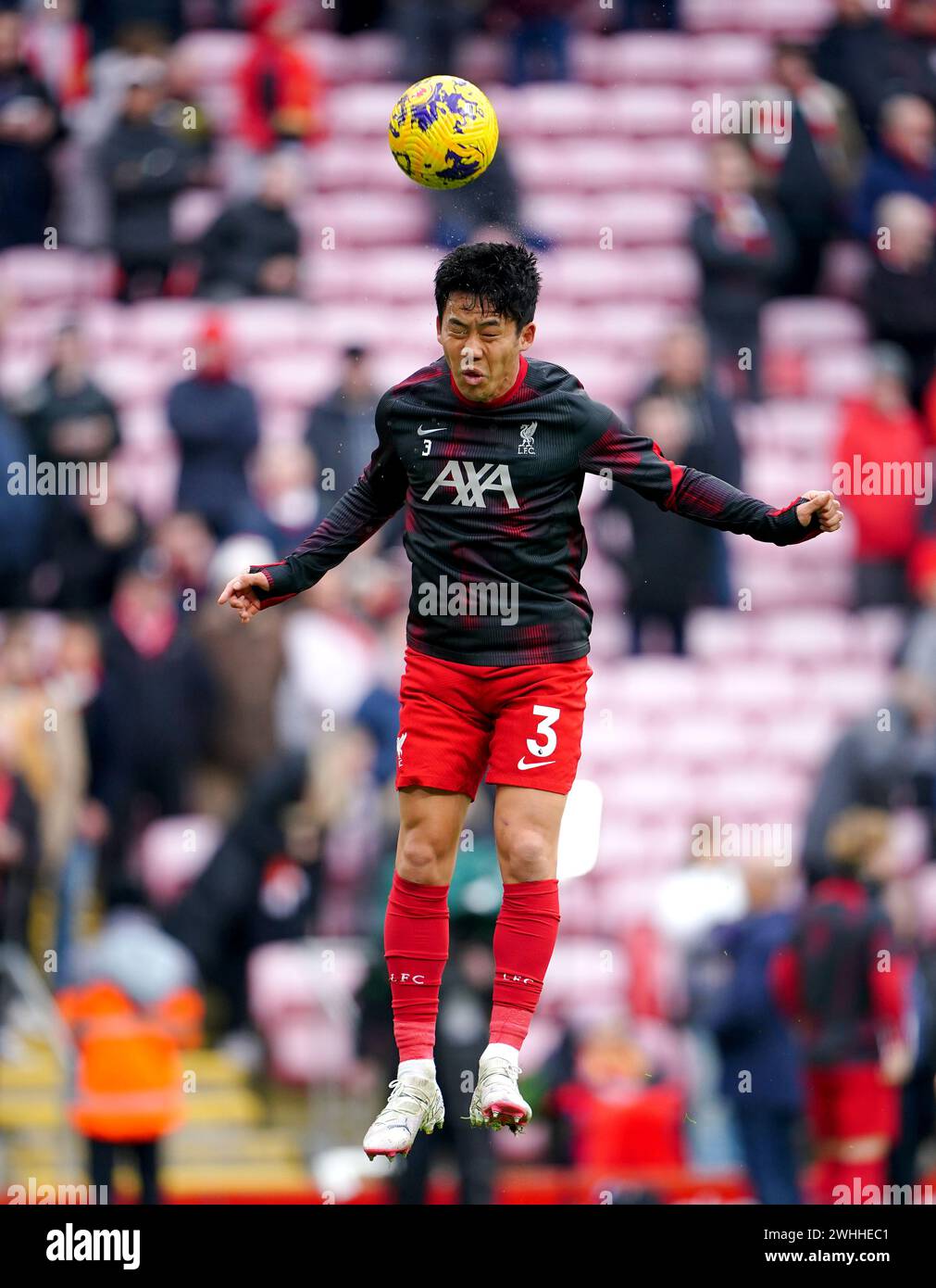Liverpool's Wataru Endo warms up ahead of the Premier League match at ...