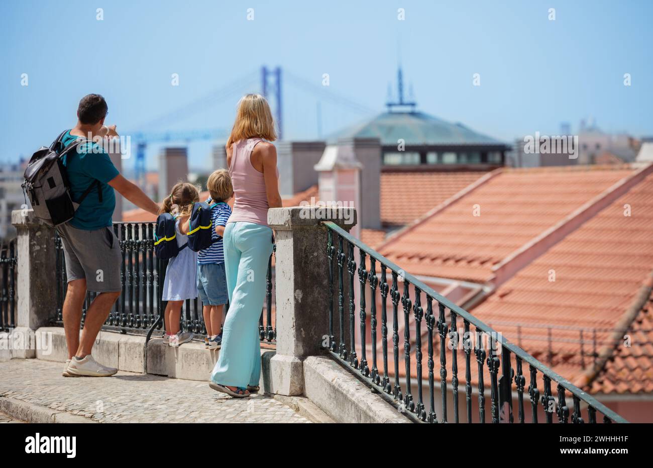 Kids with backpacks and their parents sightseeing in Lisbon Stock Photo ...