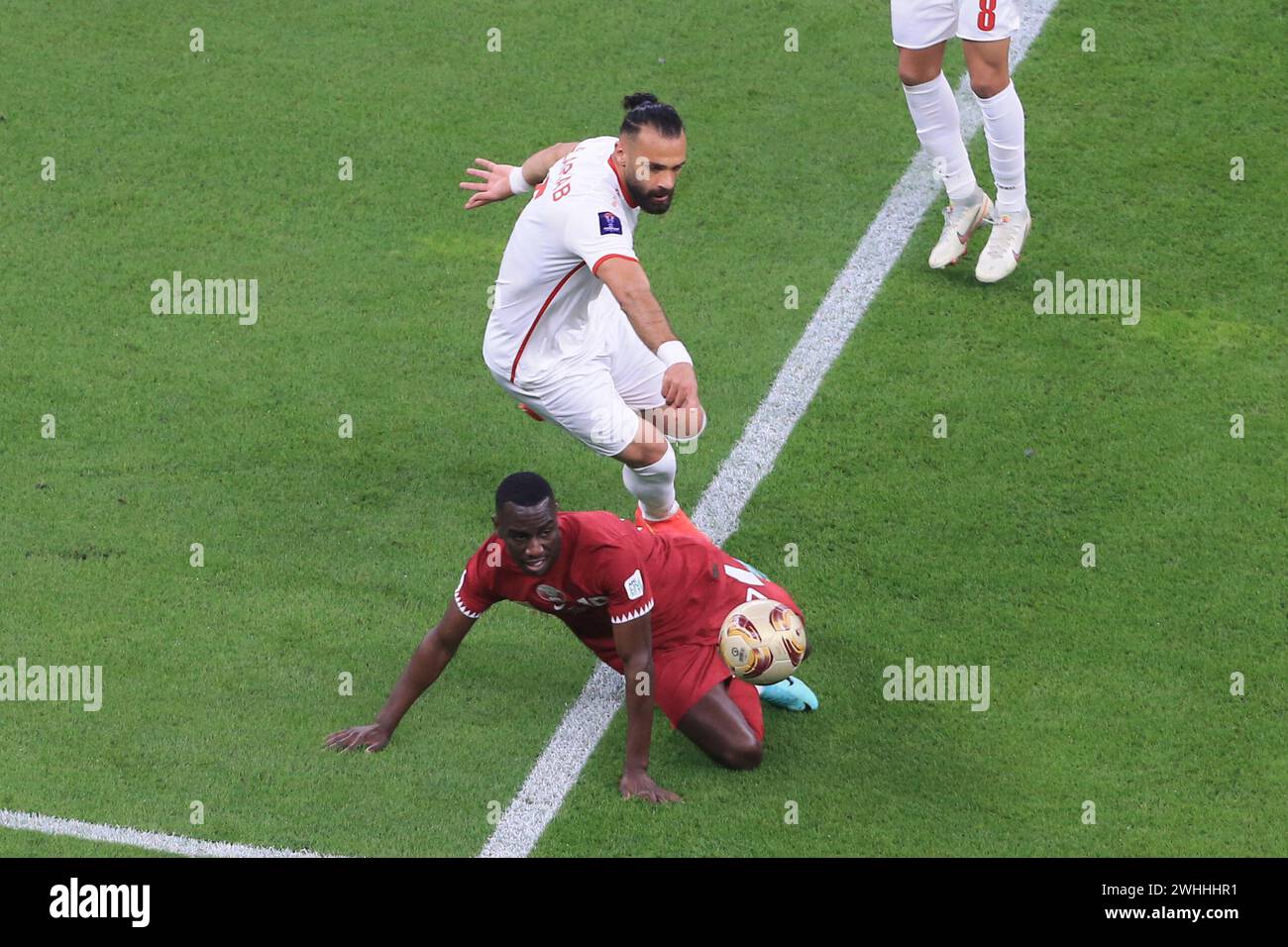 Qatar's Almoez Ali on ground and Jordan's Yazan Alarab fights for the ...