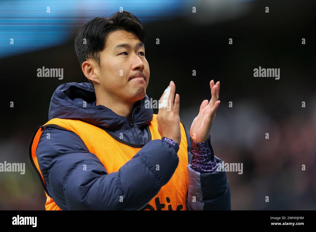 Tottenham's Son Heung-min applauds as he warms up during the English Premier League soccer match ...