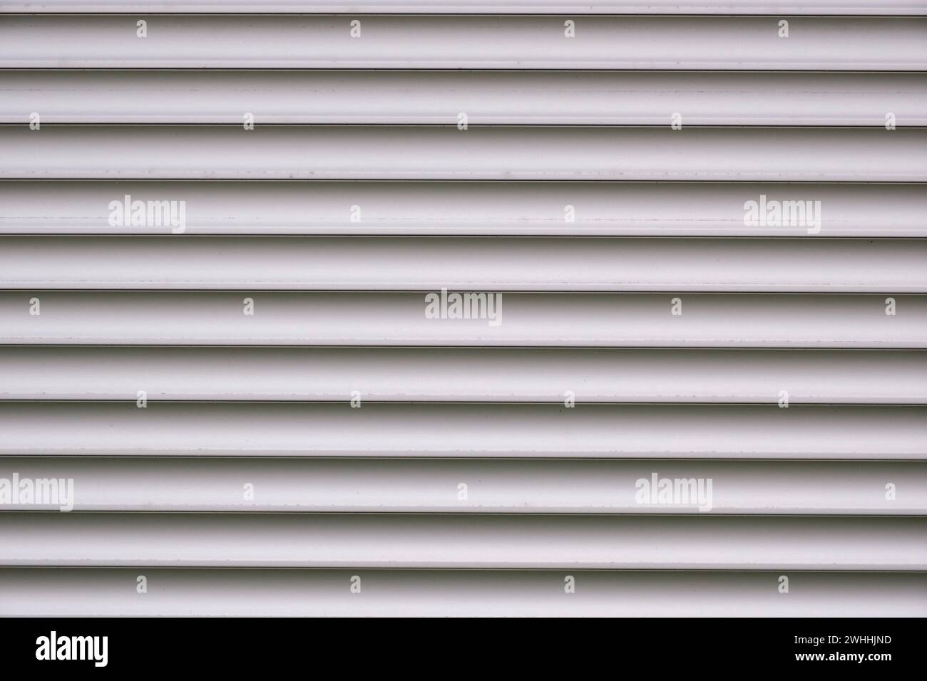 Facade with closed roller shutter Stock Photo - Alamy