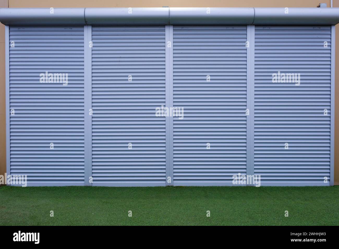 Facade with closed roller shutter Stock Photo - Alamy