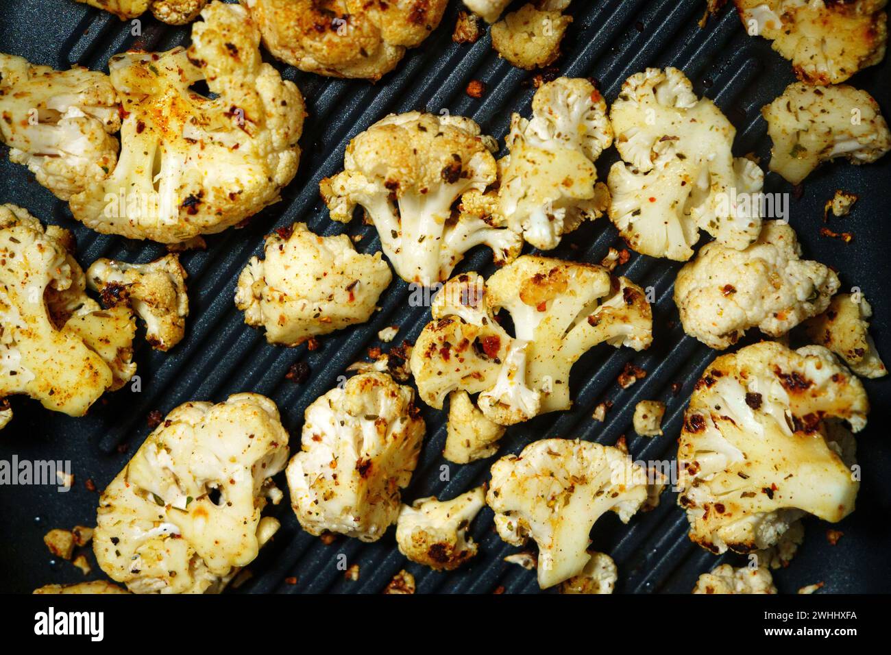 Grill showcasing mouth watering cauliflower cooking to perfection and ...
