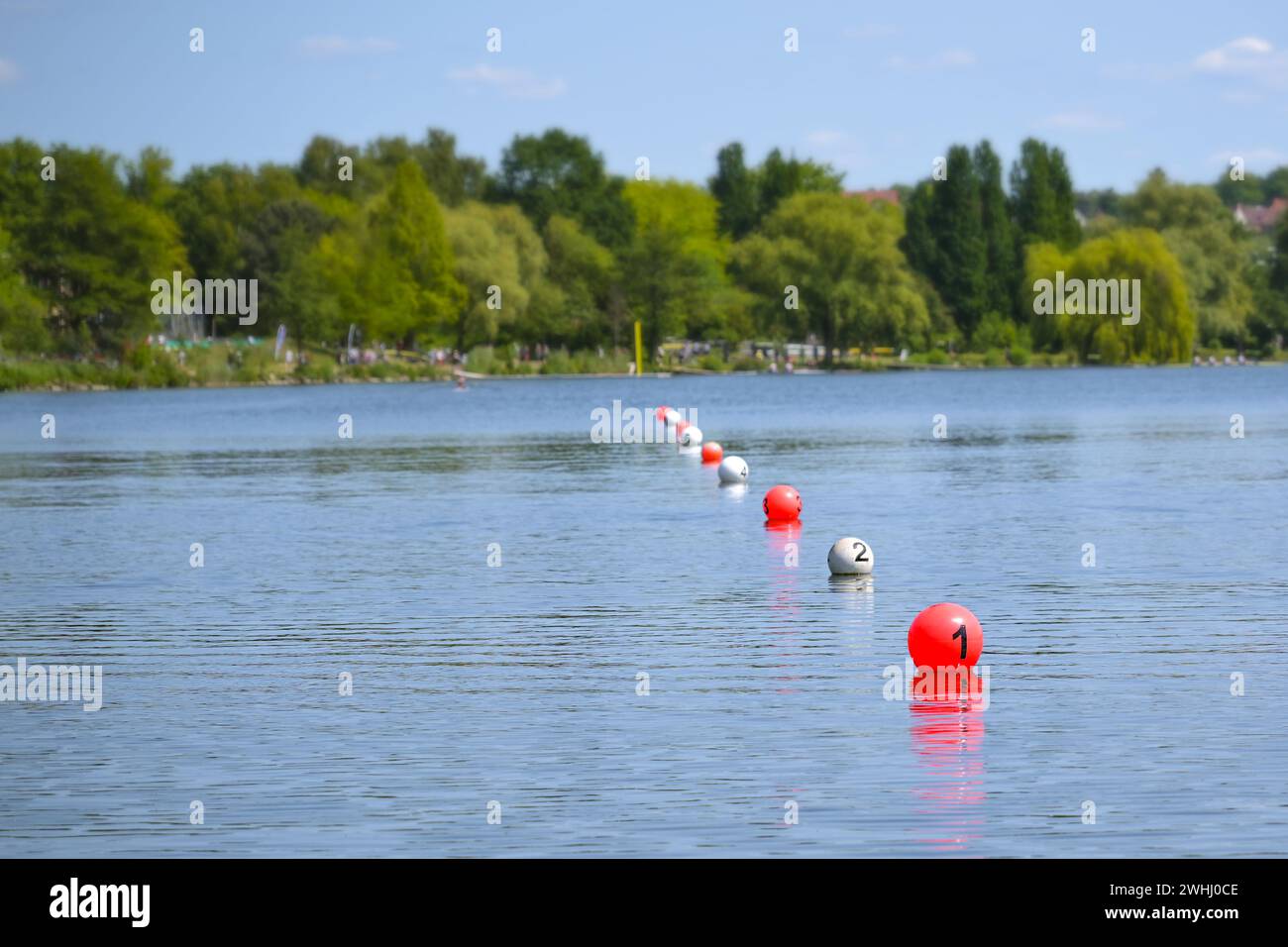 Floating balls in red and white mark the finish line on the lake during ...