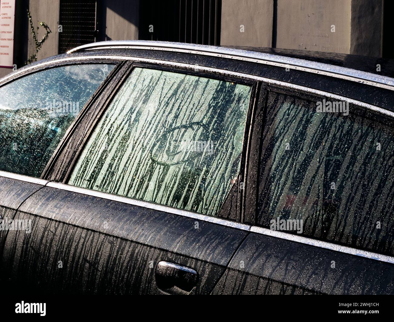 A smiley face hand drawn in the dew on a car window Stock Photo - Alamy
