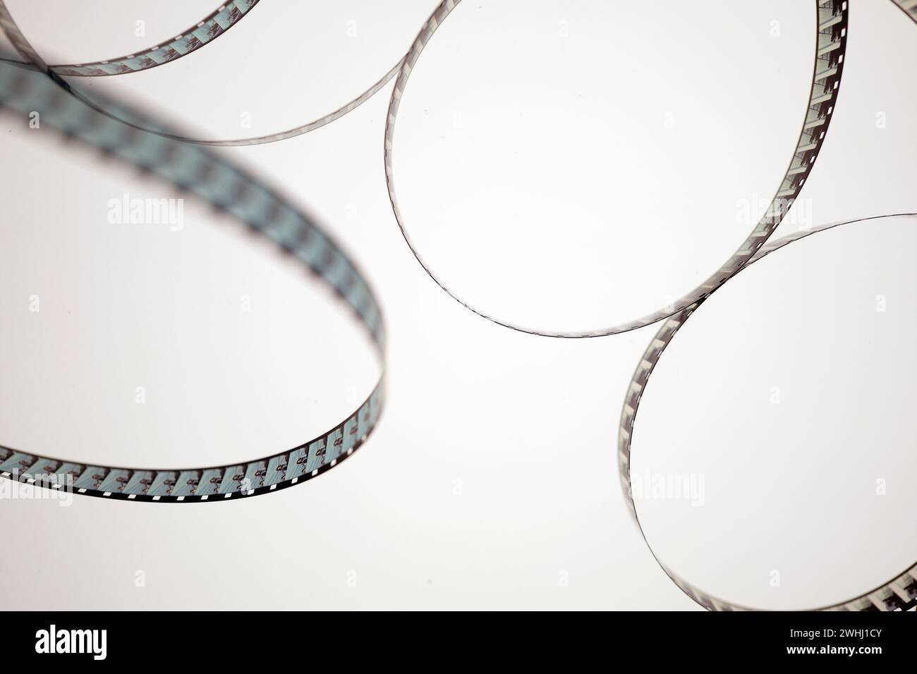 loops of 8mm cine film against a white background Stock Photo - Alamy