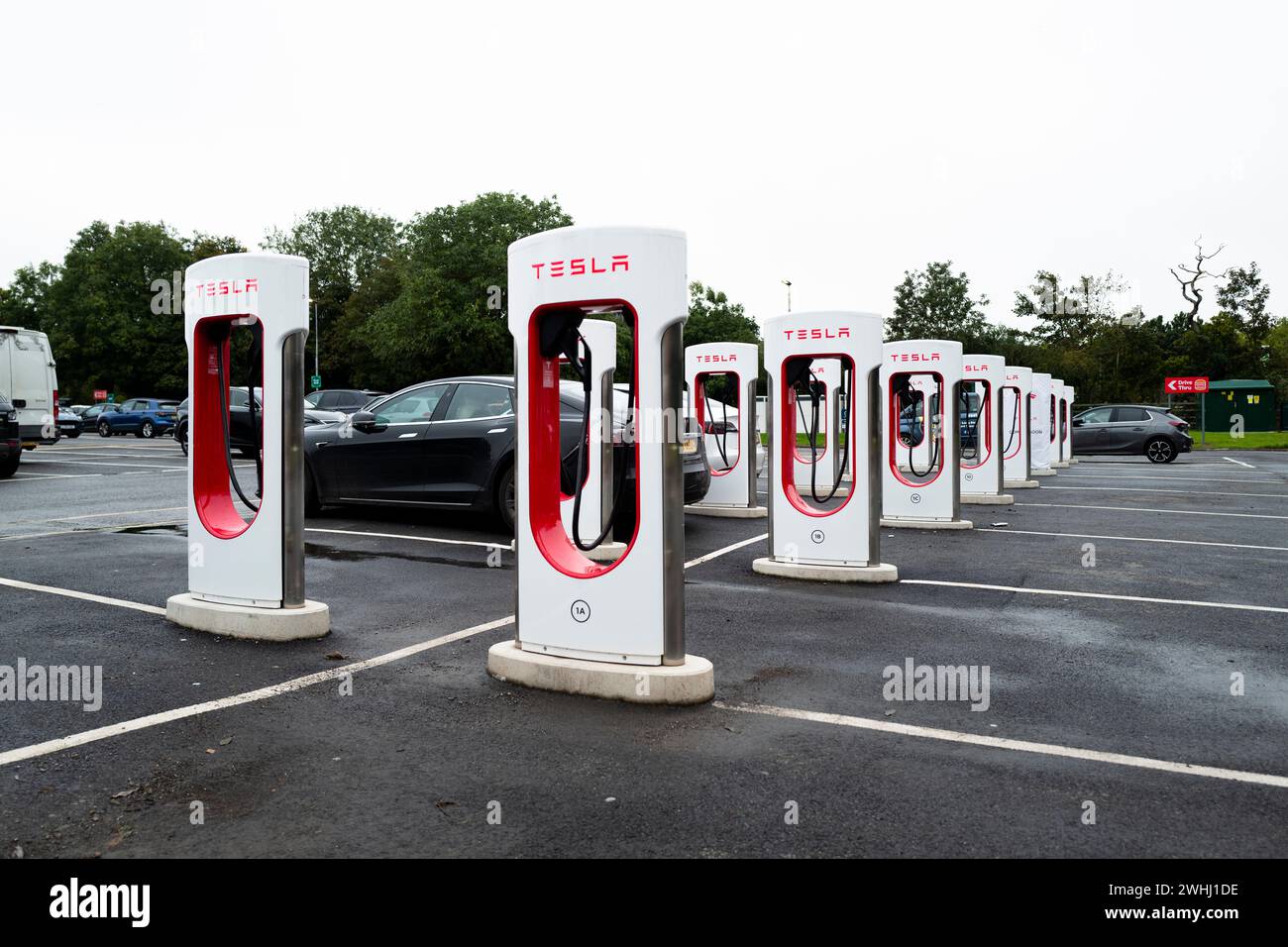 Electric vehicle charging machines at a Motorway service station Stock ...
