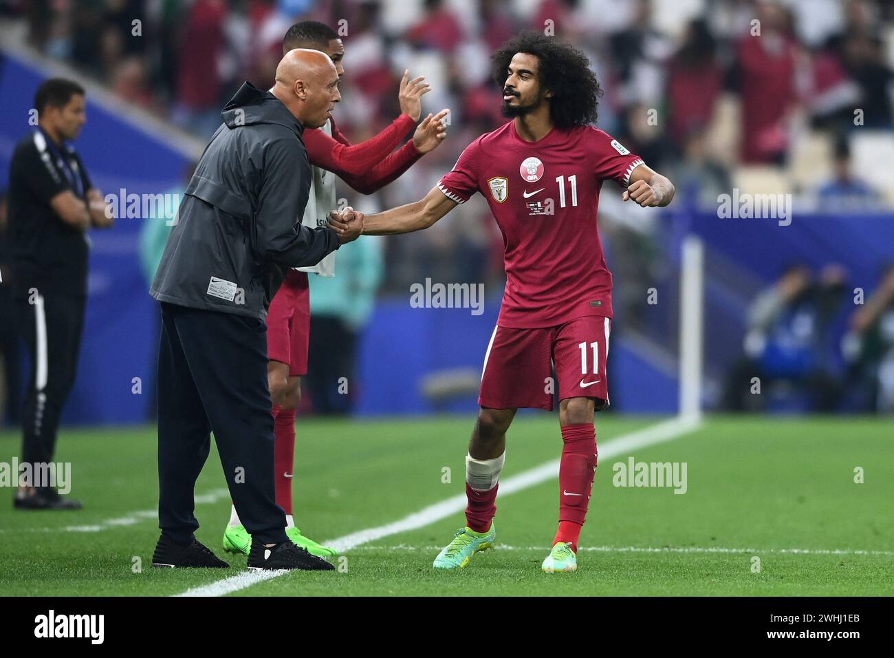 Lusail, Qatar. 10th Feb, 2024. Akram Afif (R) of Qatar celebrates ...