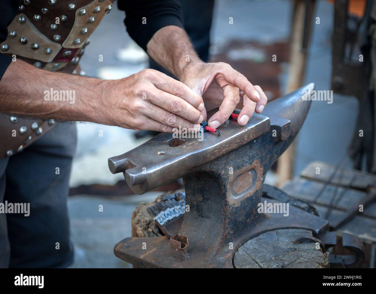 Metal craftsman in foreground with medieval background Stock Photo - Alamy