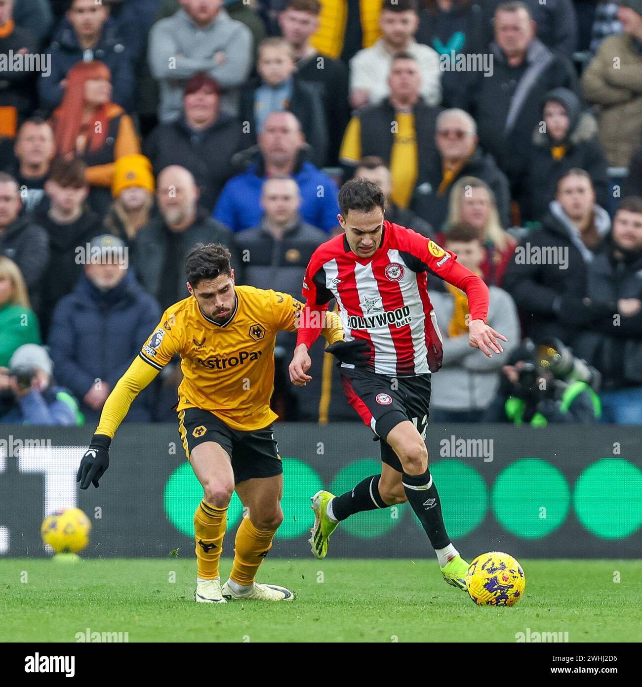 Wolverhampton, UK. 10th Feb, 2024. Wolves' Pedro Neto is held off bony ...