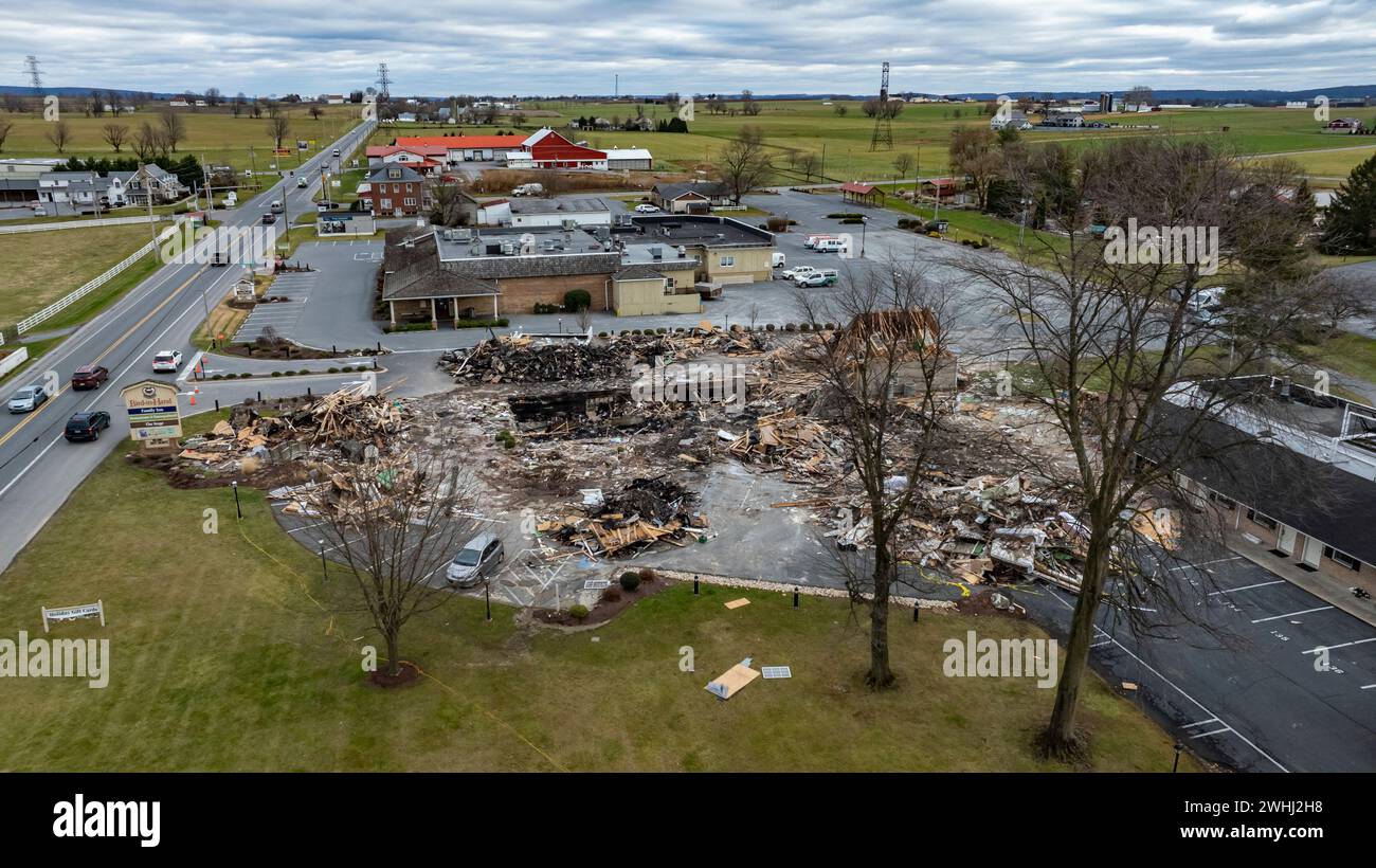 An Aerial View Of A Devastated Building Amidst Intact Structures With ...