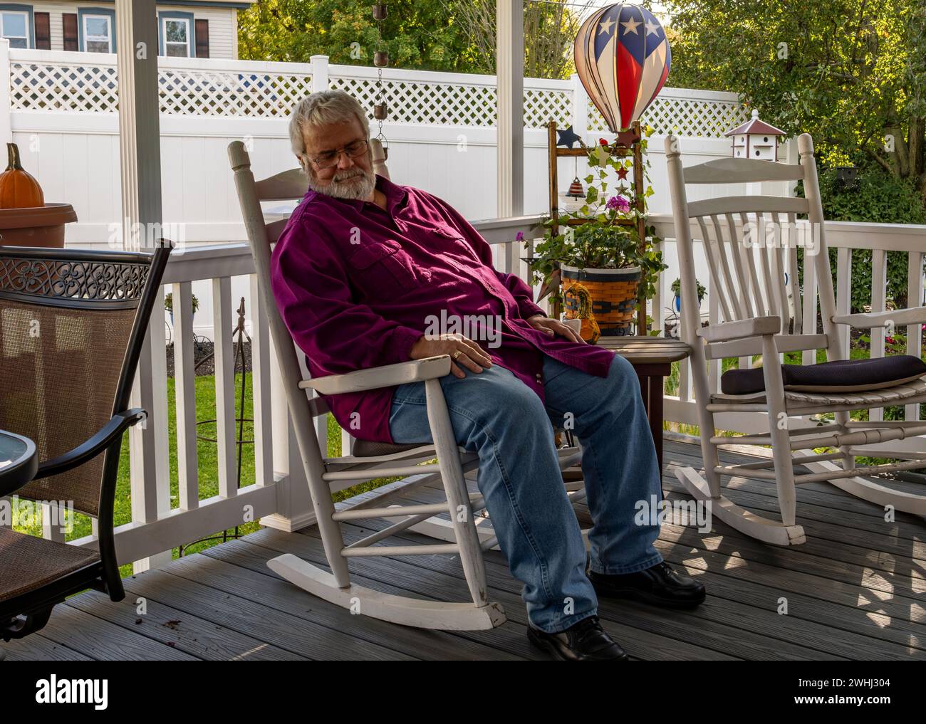 A Senior Aged Male Sleeping in a Rocking Chair, on a Deck, Enjoying His ...