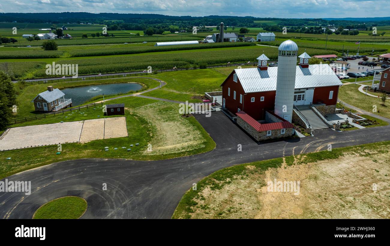 Overlooking A Farmstead Featuring A Majestic Red Barn With Silo, An ...