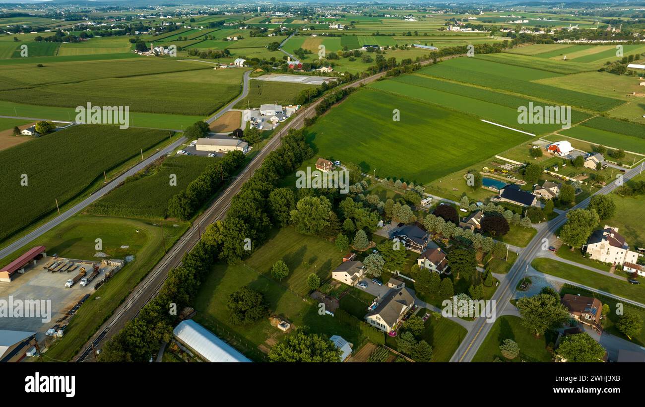Elevated View Of A Tranquil Rural Area With Lush Fields, A Railroad ...