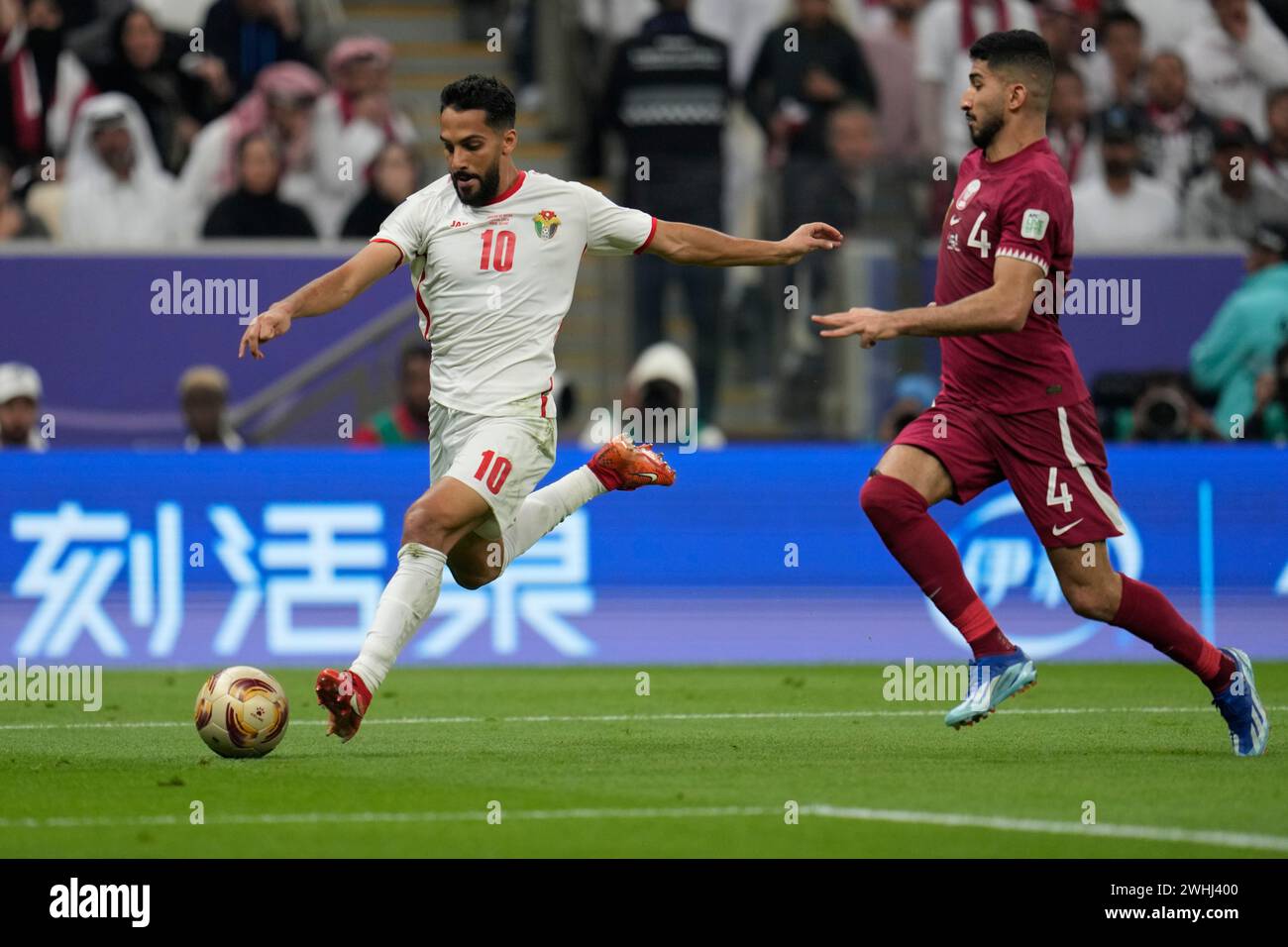 Jordan's Mousa Altamari, left, is challenged by Qatar's Mohammed Waad ...
