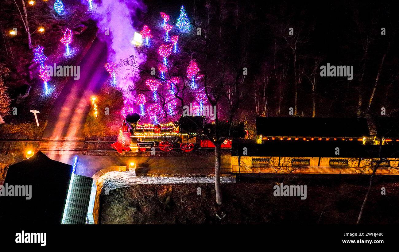 Nighttime Aerial Shot Of An Illuminated Steam Locomotive With Red ...