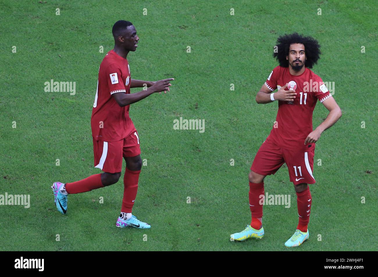 Qatar's Akram Afif, right, celebrates after scoring a goalduring the ...