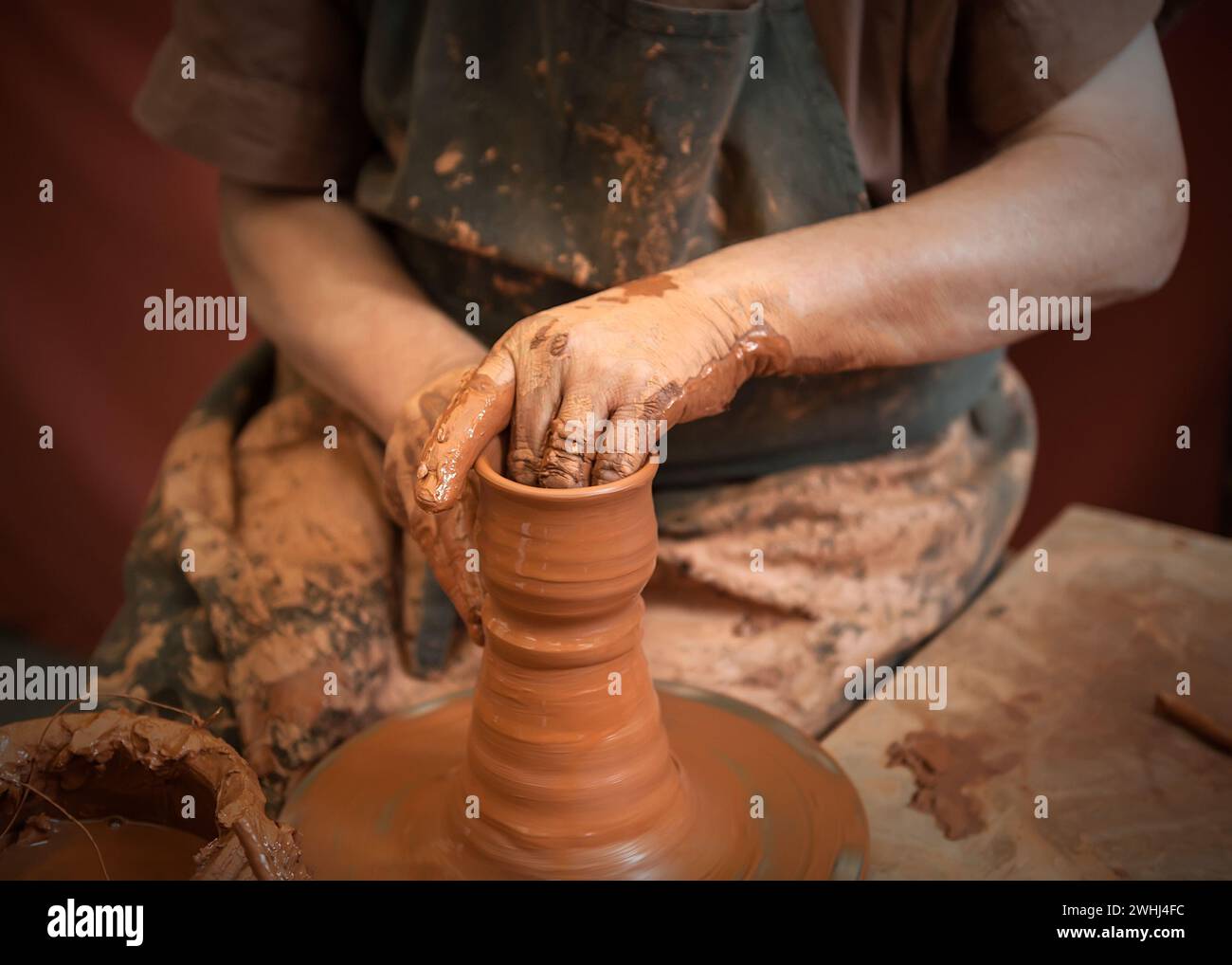 potter working on the lathe with a lump of clay Stock Photo - Alamy