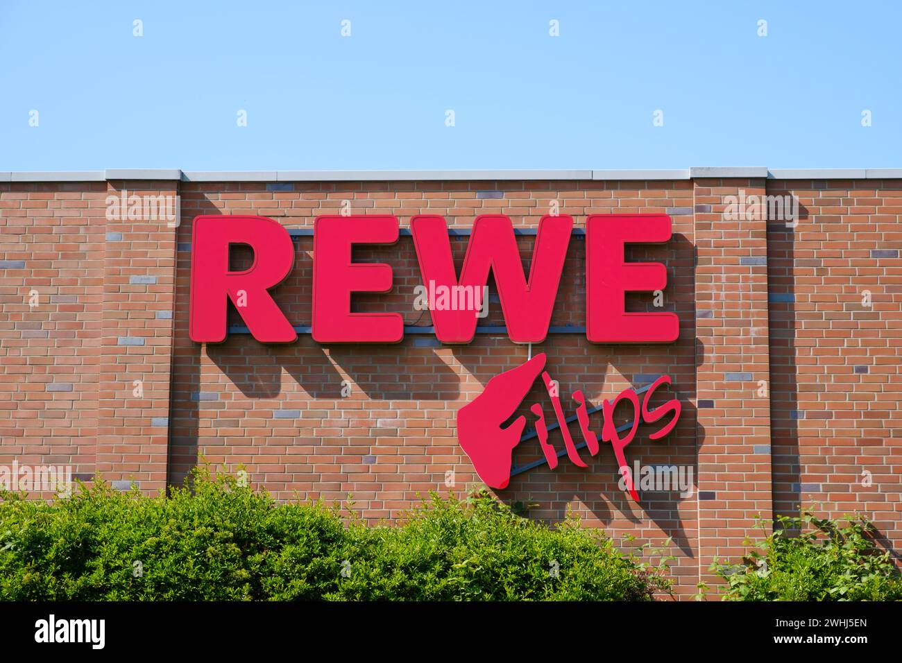 Facade with sign and logo REWE Stock Photo - Alamy