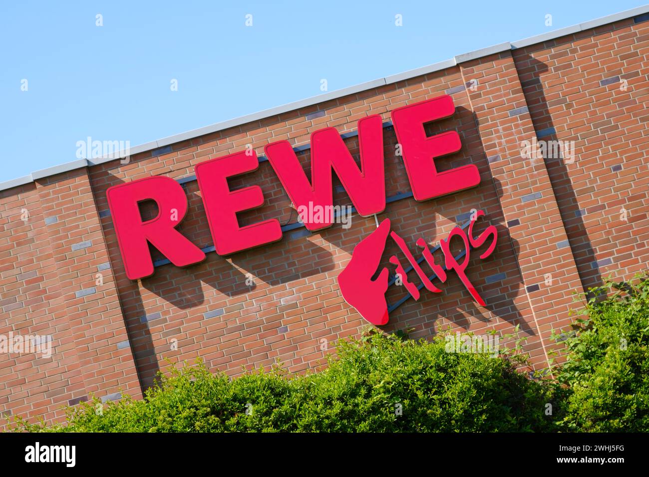 Facade with sign and logo REWE Stock Photo - Alamy
