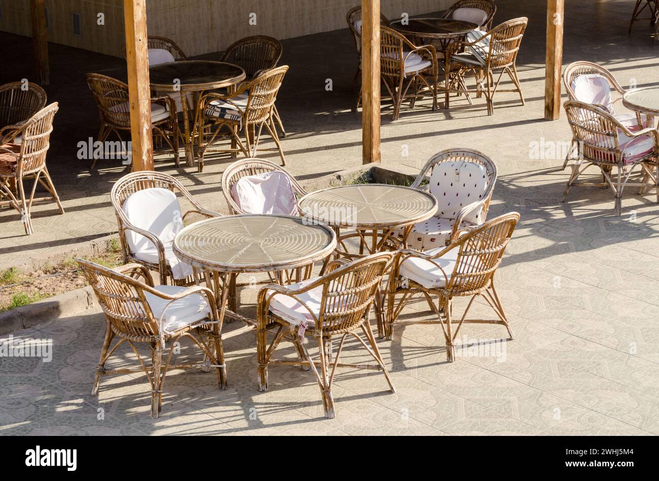 Wooden chairs and round tables in an empty hotel cafe in Egypt Dahab ...