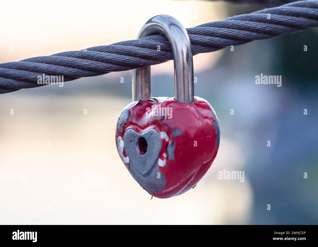 Red peeling wedding lock on a rope with a key hole Stock Photo - Alamy