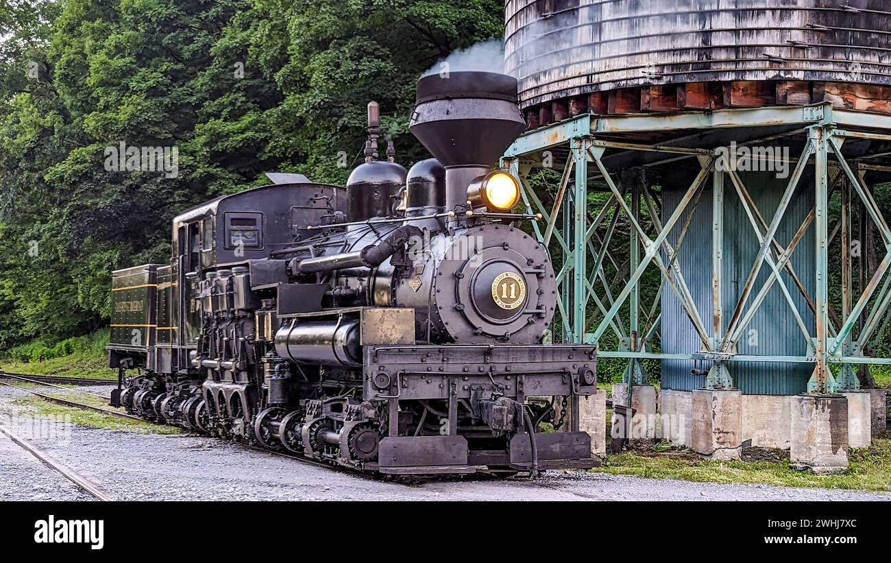 View of an Antique Shay Steam Engine Warming Up by an Old Water Tower ...