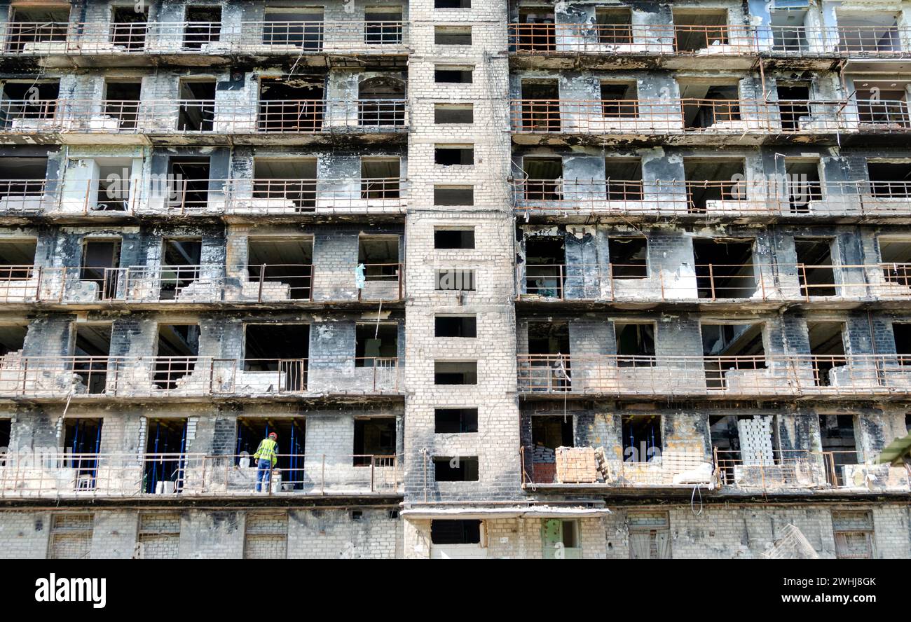 Builder at work on the restoration and repair of destroyed houses in ...