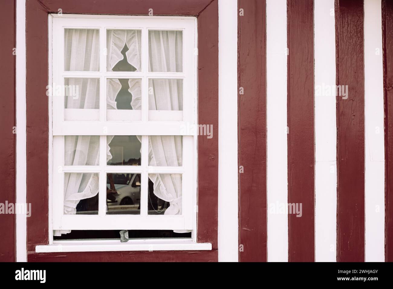 Vintage window on a red and white striped wall Stock Photo - Alamy