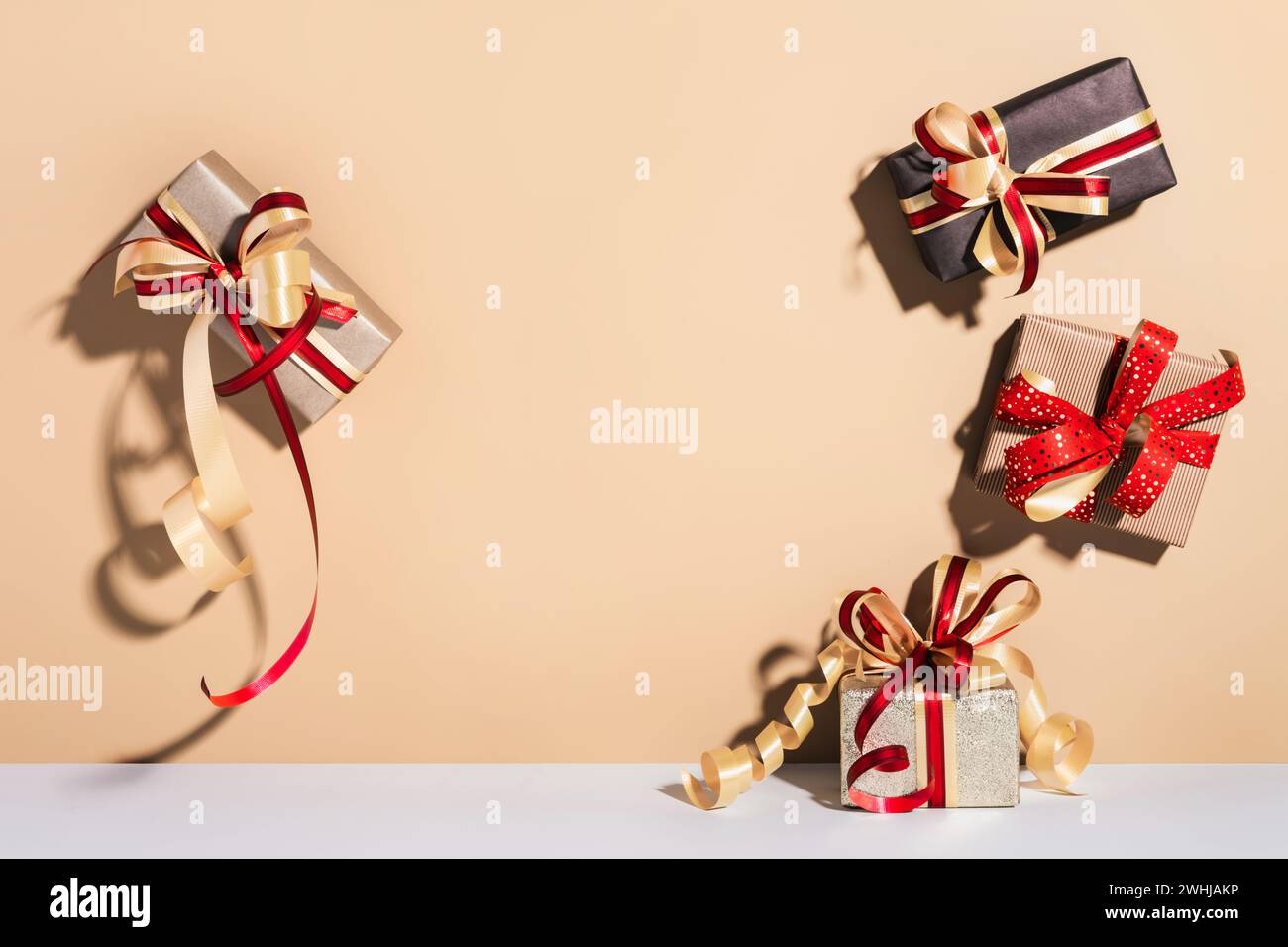 Gift boxes set on wall floor background. Gifts wrapped in kraft paper ...