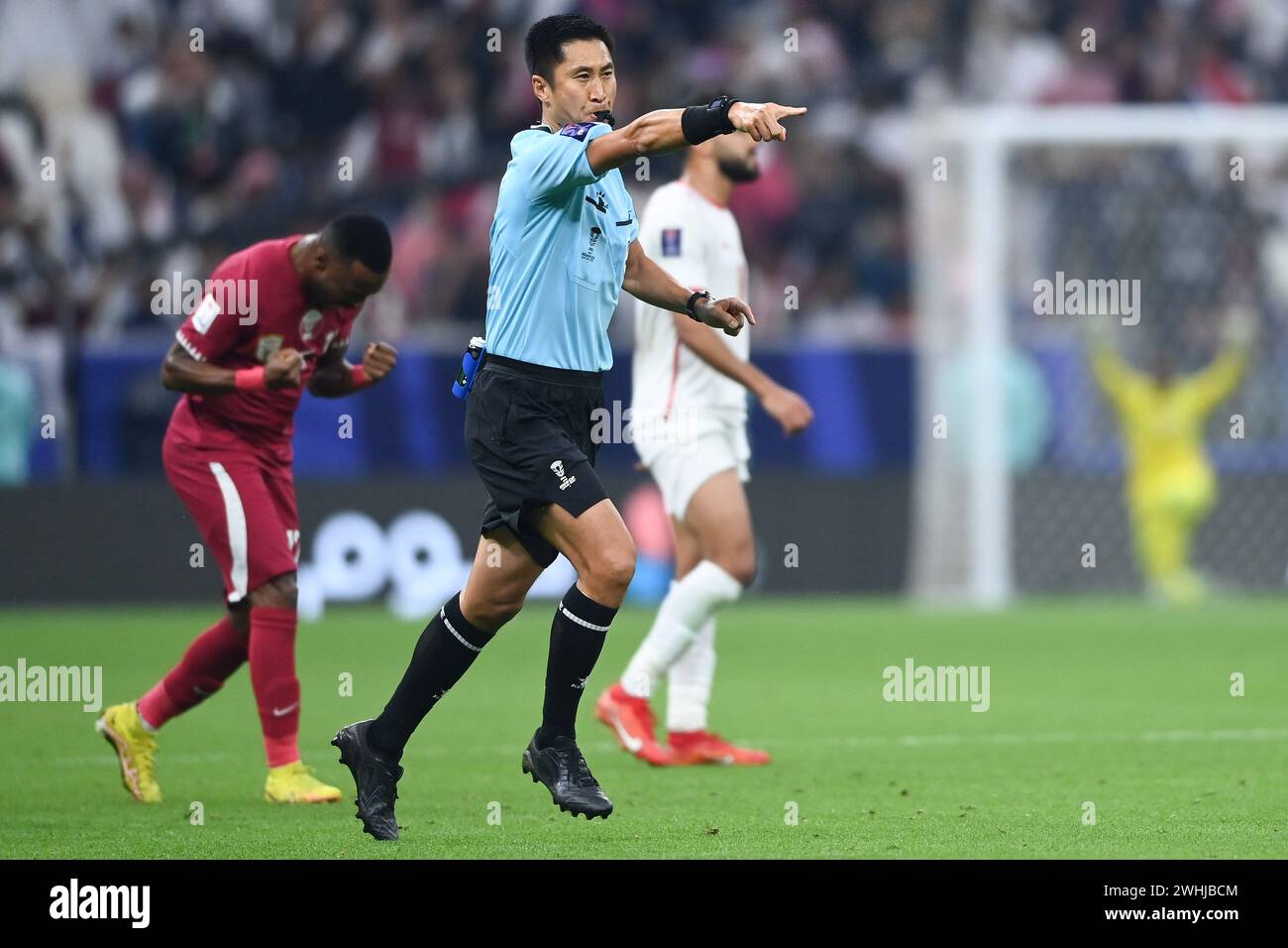 Lusail, Qatar. 10th Feb, 2024. Referee Ma Ning gives a penalty to Qatar ...