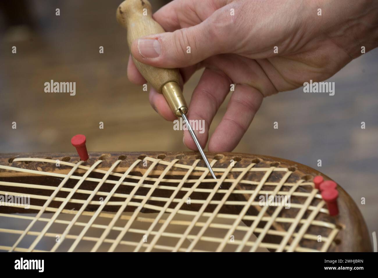 a basket maker weaves a basket, crafting and producing with wood Stock ...