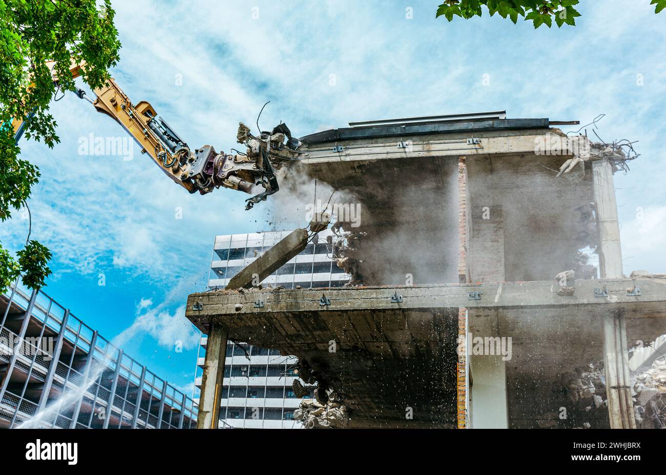 Process of demolition of old building dismantling. Excavator breaking ...