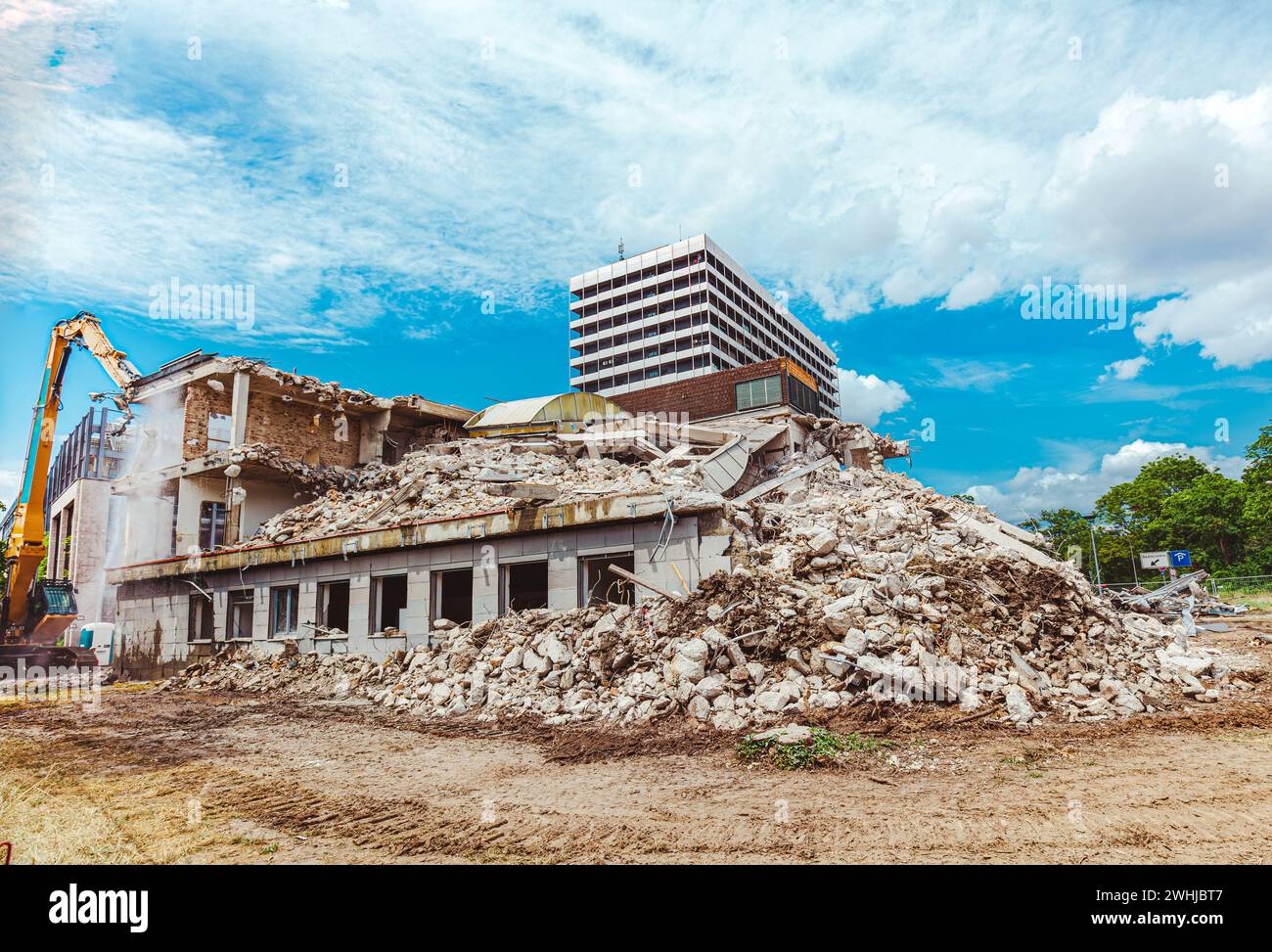 Process of demolition of old building dismantling. Excavator breaking ...