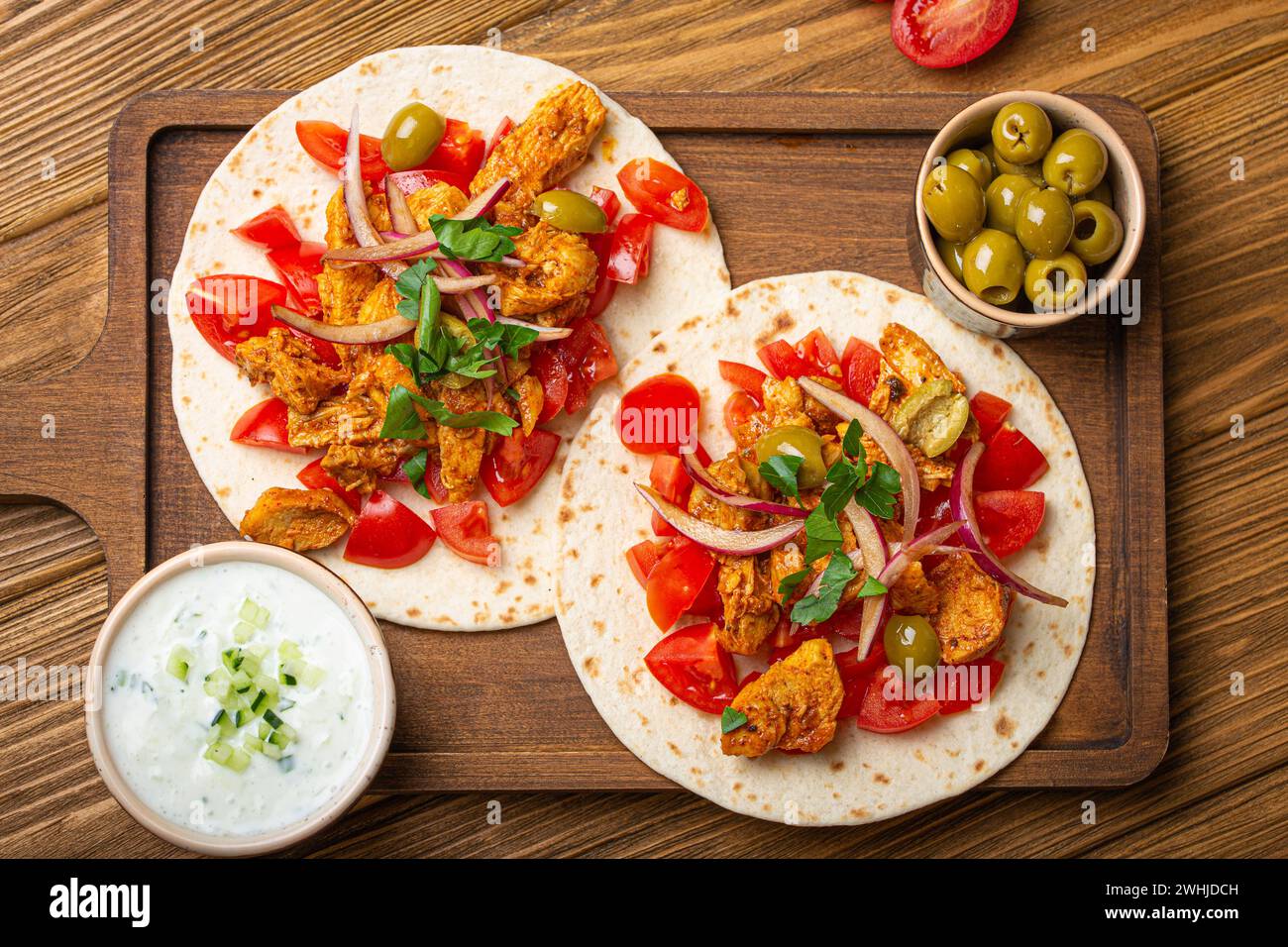 Cooking Traditional Greek Dish Gyros: Pita bread with vegetables, meat ...