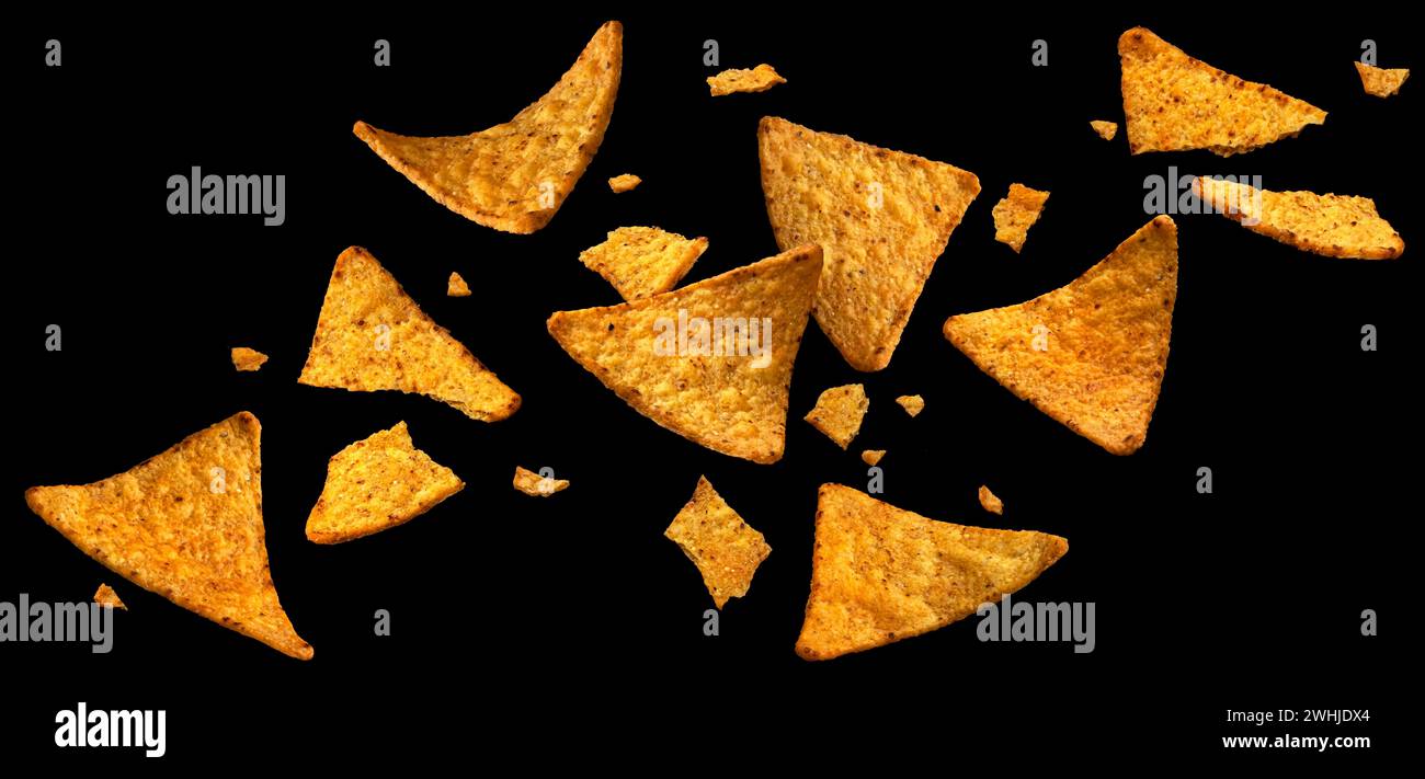 Falling corn chips, hot Mexican nachos isolated on black background ...