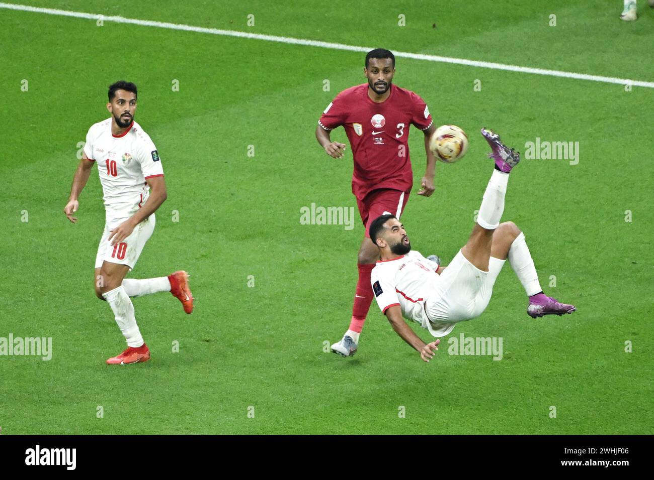 Lusail, Qatar. 10th Feb, 2024. Ali Olwan (R) of Jordan shoots during ...