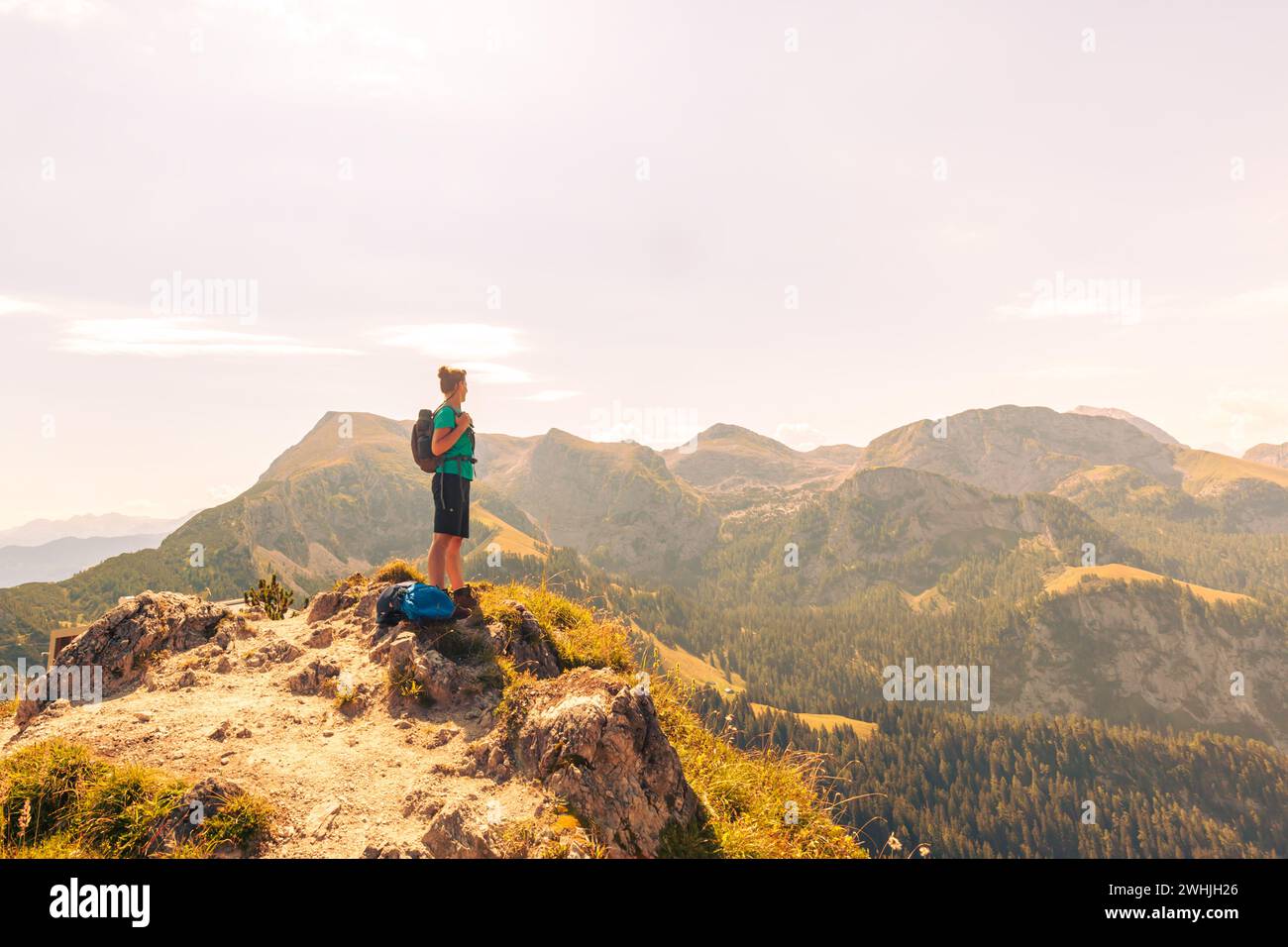 Woman Hiking in the alps. Relaxing, resting on a Stone. Jenner Mountain ...