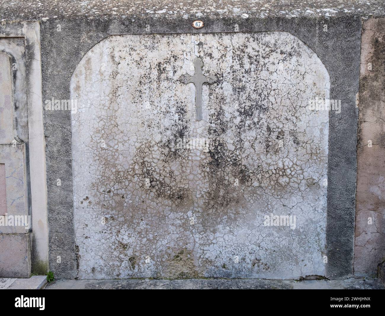 Cross on tombstone wall Stock Photo - Alamy