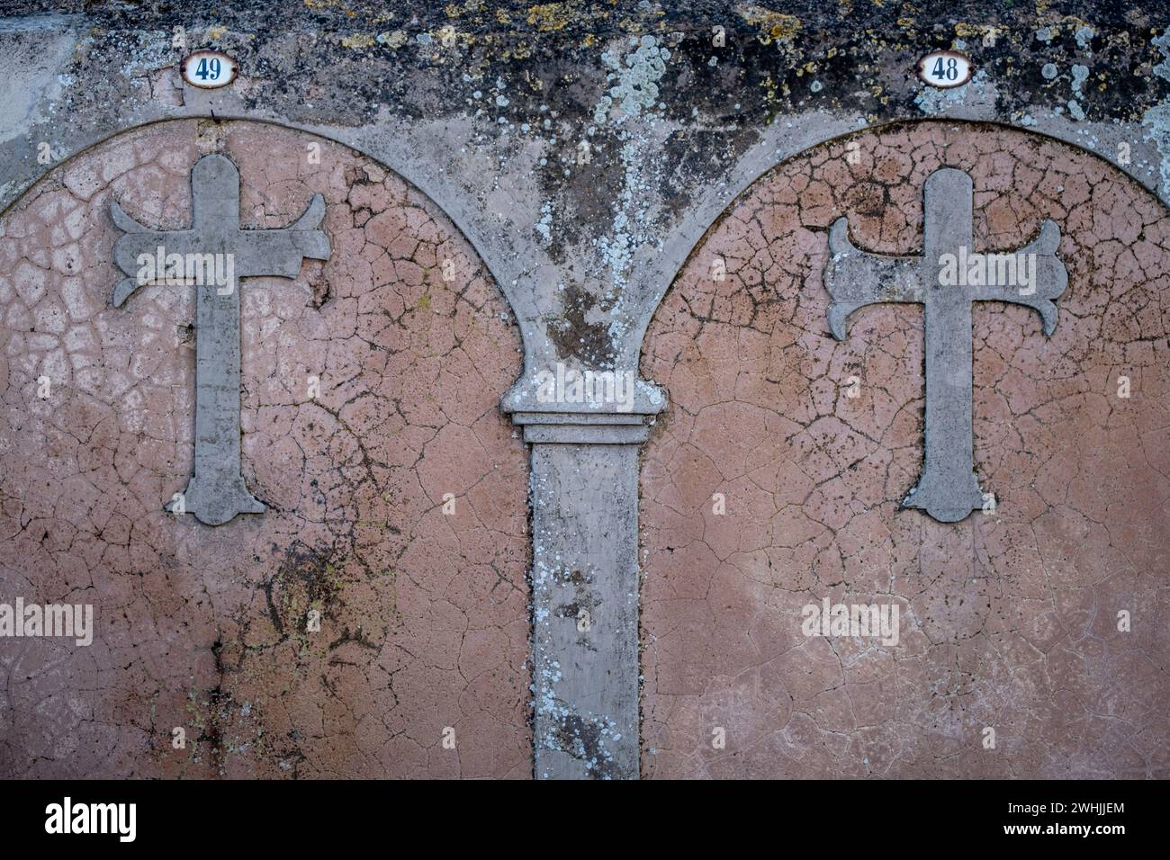 Cross on tombstone wall Stock Photo - Alamy