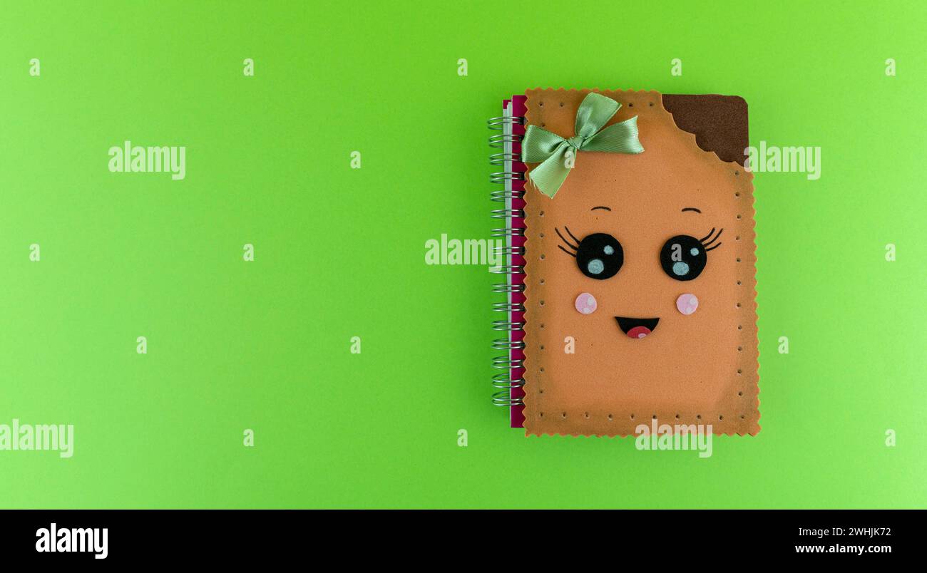 Handmade little cute cookie notebook on the green background Stock ...