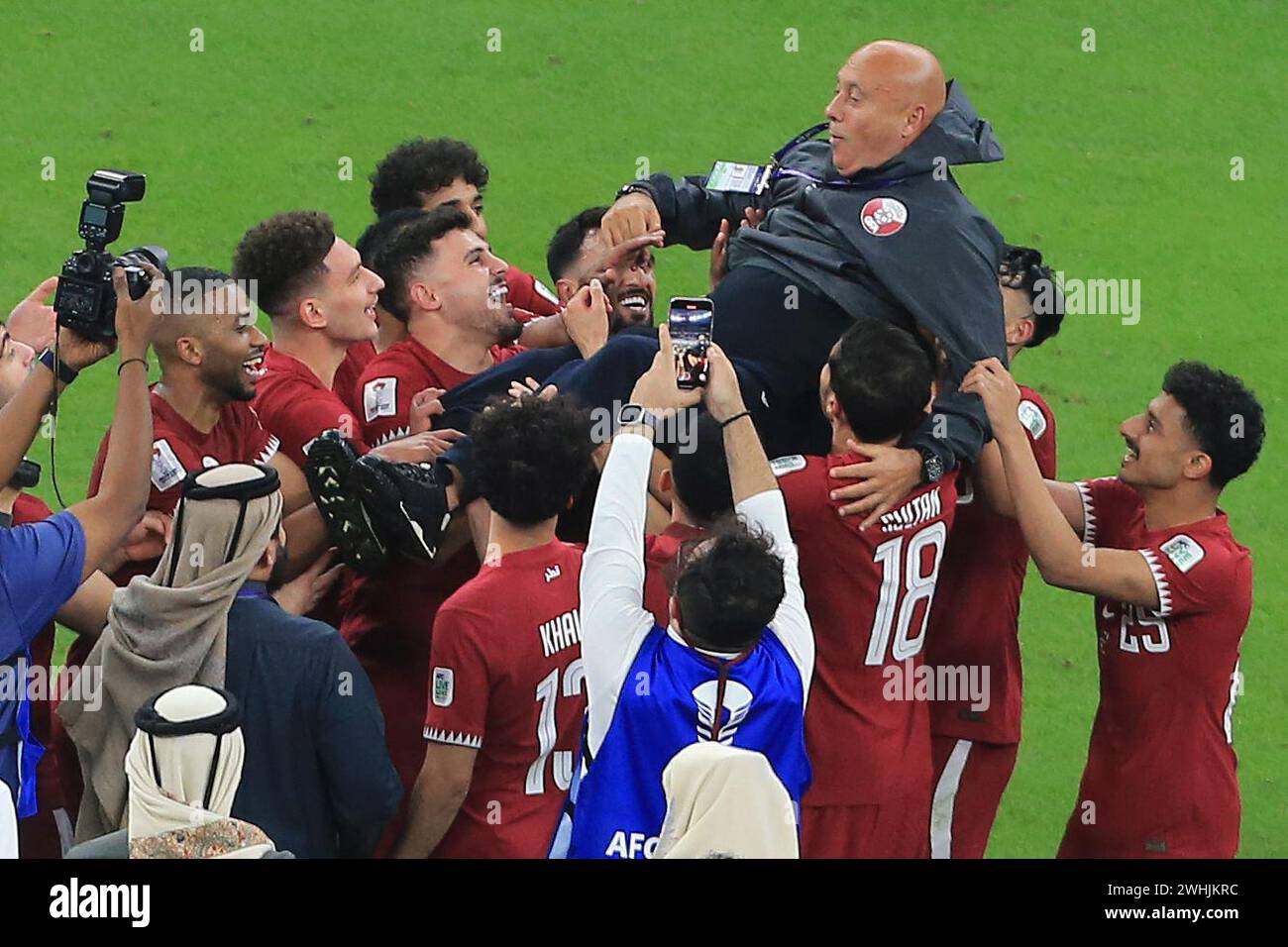 Qatar players lift Qatar's head coach Bartolome Marquez at full time of ...